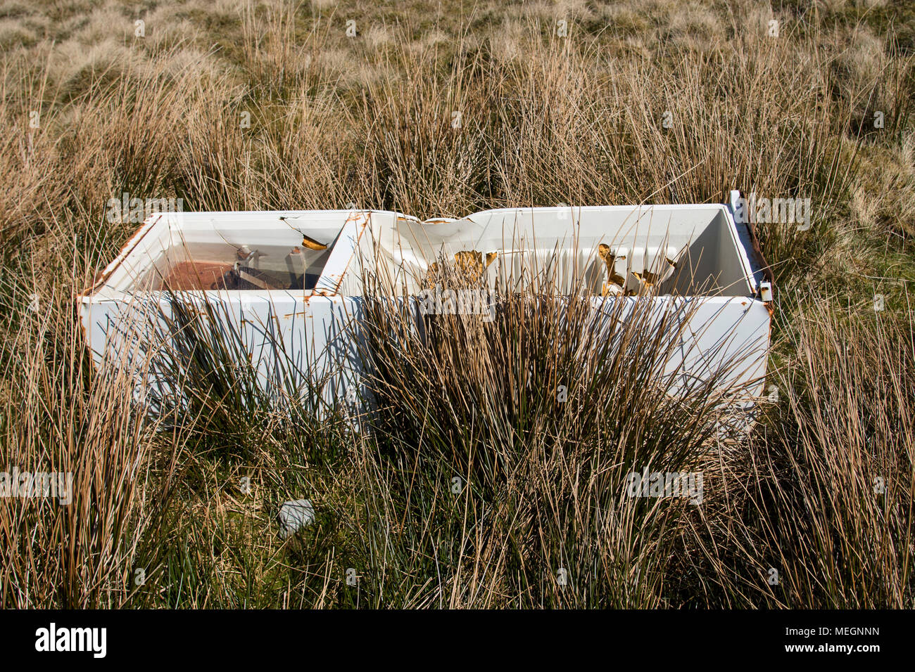 Fly tipped fridge freezer dumped on a moorland in North Wales. The ...