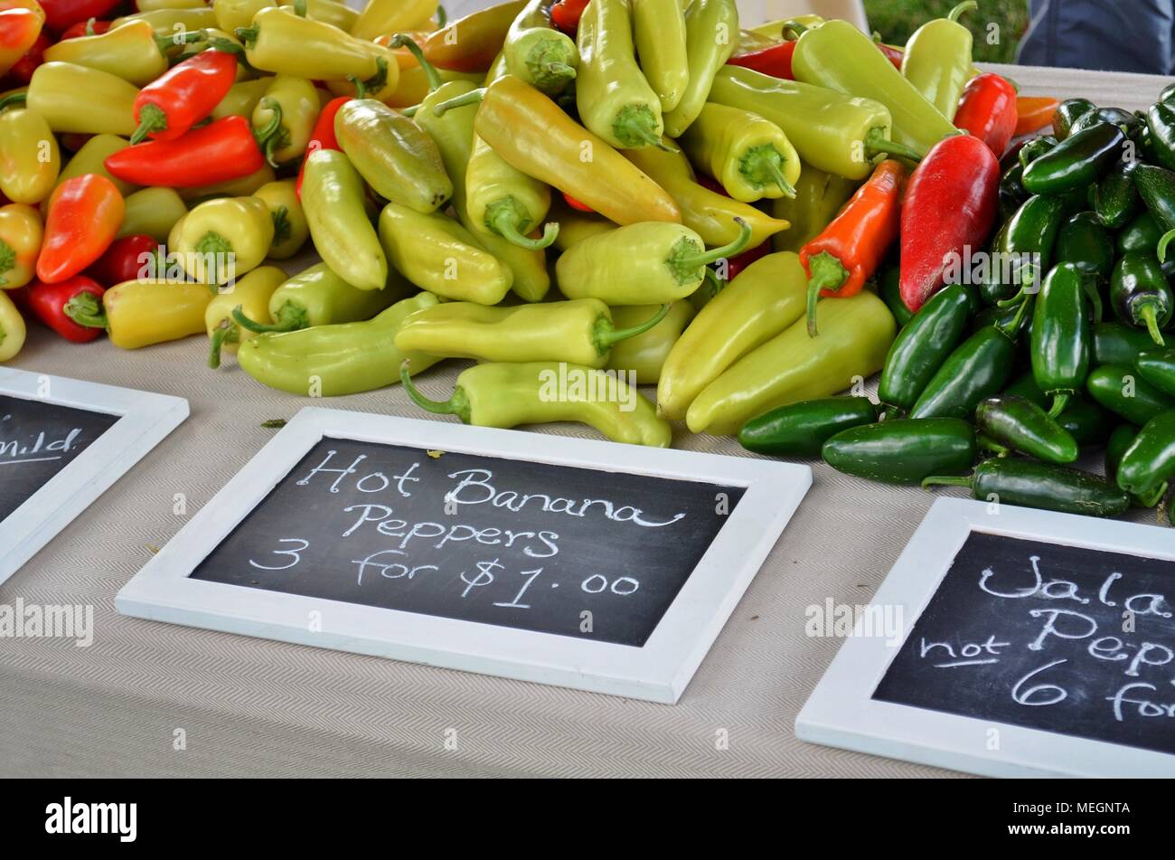 A variety of peppers on display and for sale at a local outdoor Farmers ...