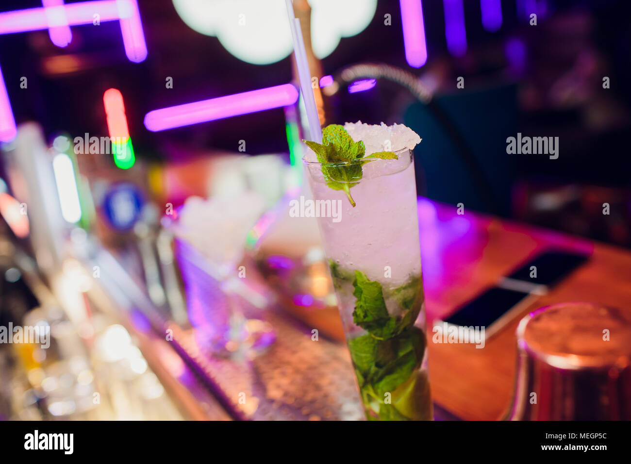 Glasses of cocktails on bar background color drink Stock Photo - Alamy