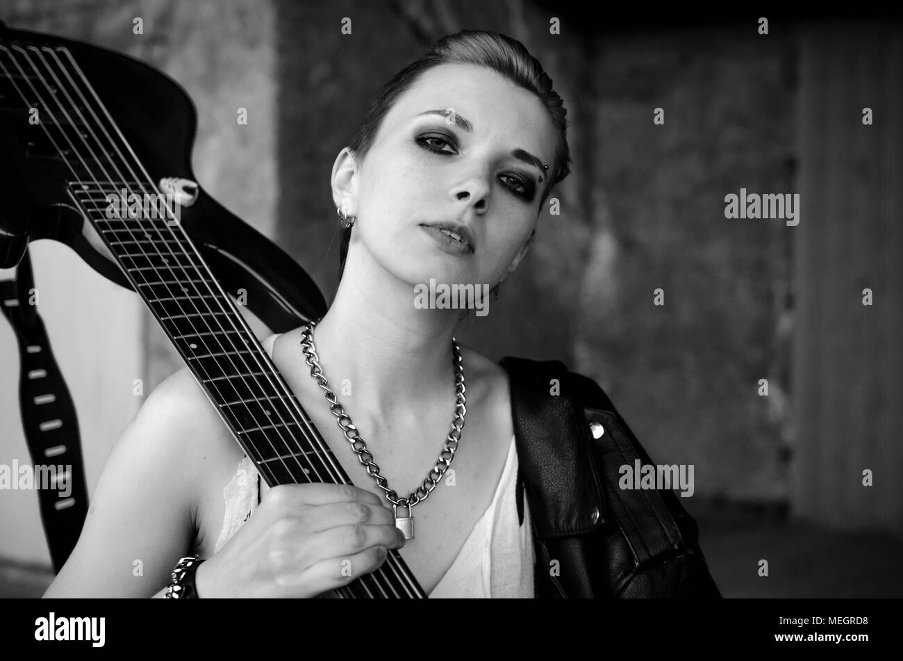 Female rockstar with guitar. Black and white photo Stock Photo - Alamy