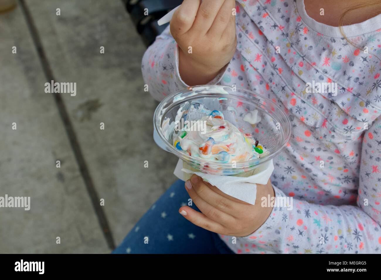 Girl eating ice cream in a cup Stock Photo - Alamy