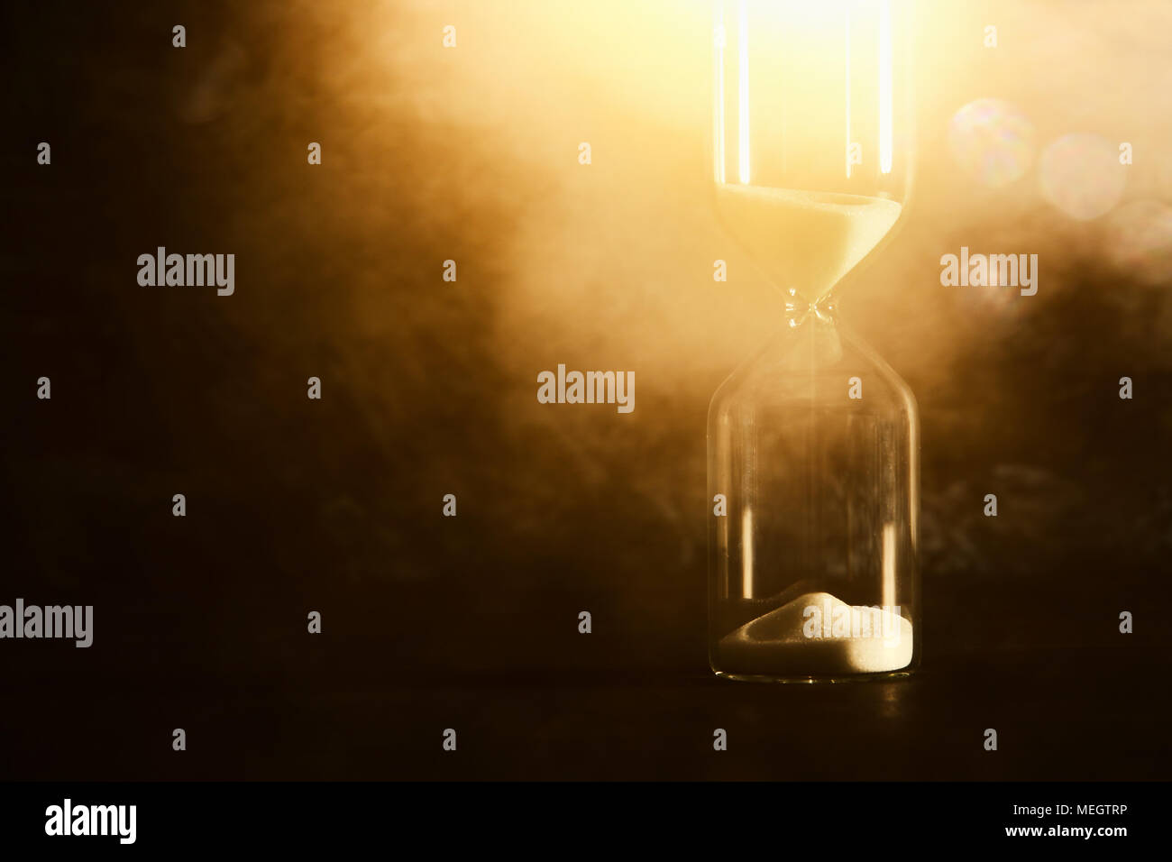 Image of hourglass as time passing concept over black background for ...