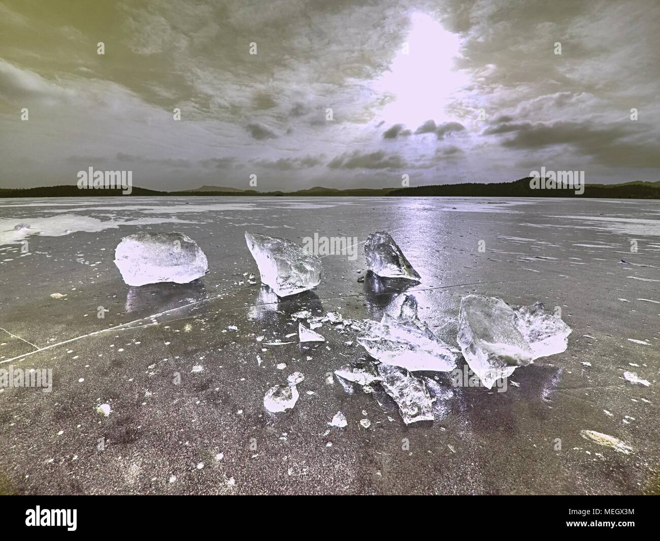 Winter view of the frozen sea to the opposite bank. The sun in ice ...
