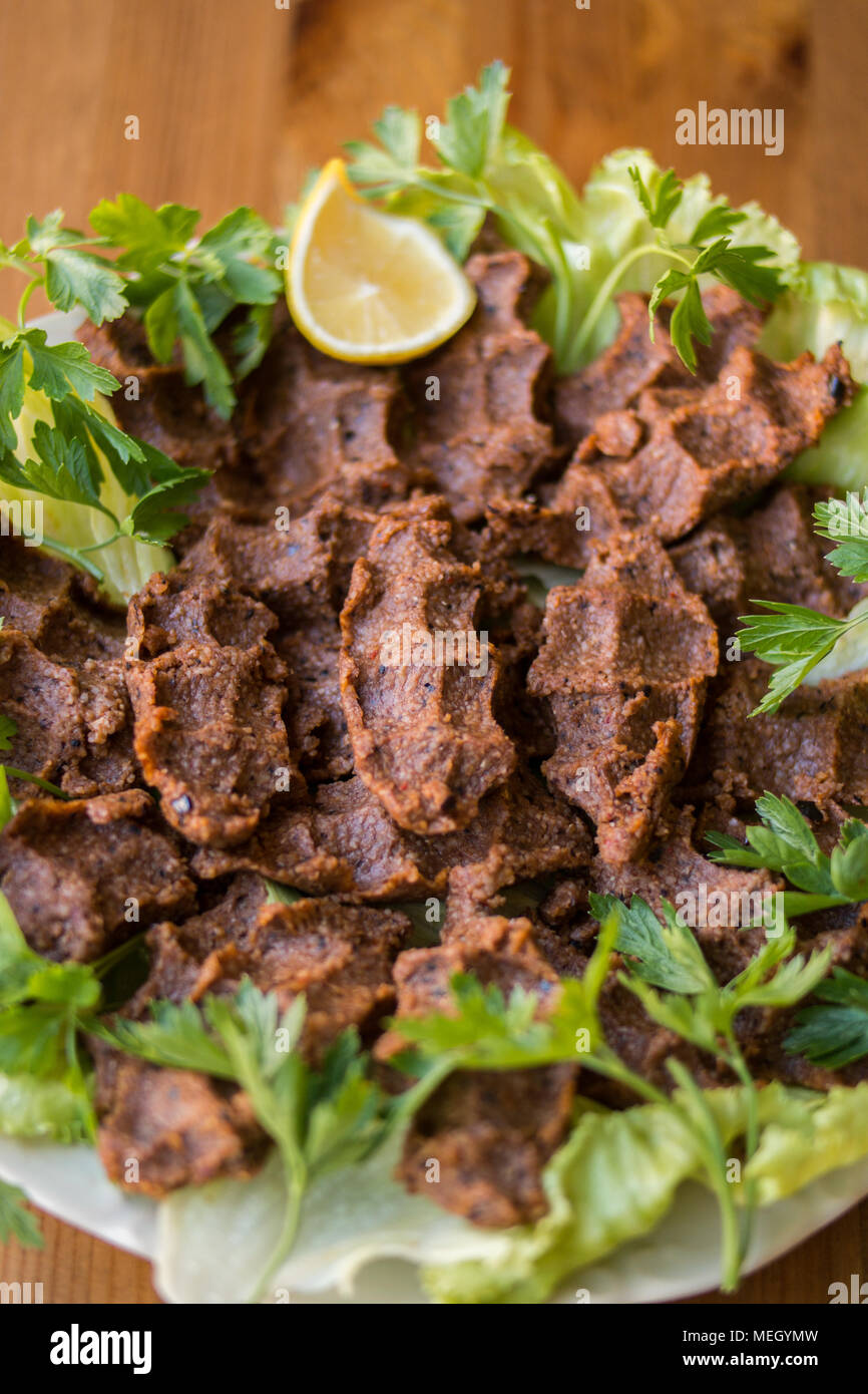 Turkish Food Cig Kofte with lemon, lettuce and parsley on silver tray ...