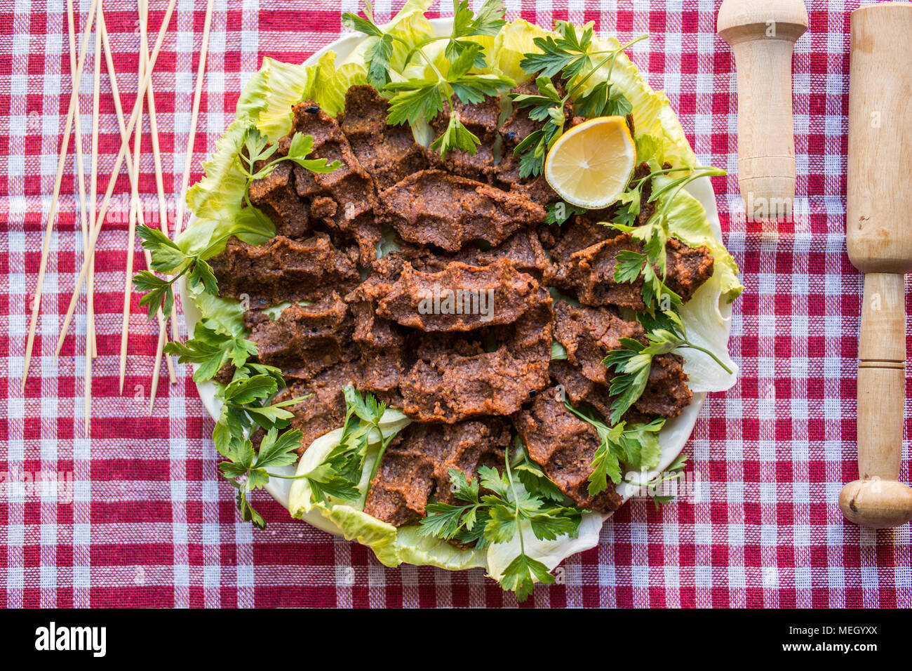 Turkish Food Cig Kofte with lemon, lettuce and parsley on silver tray ...