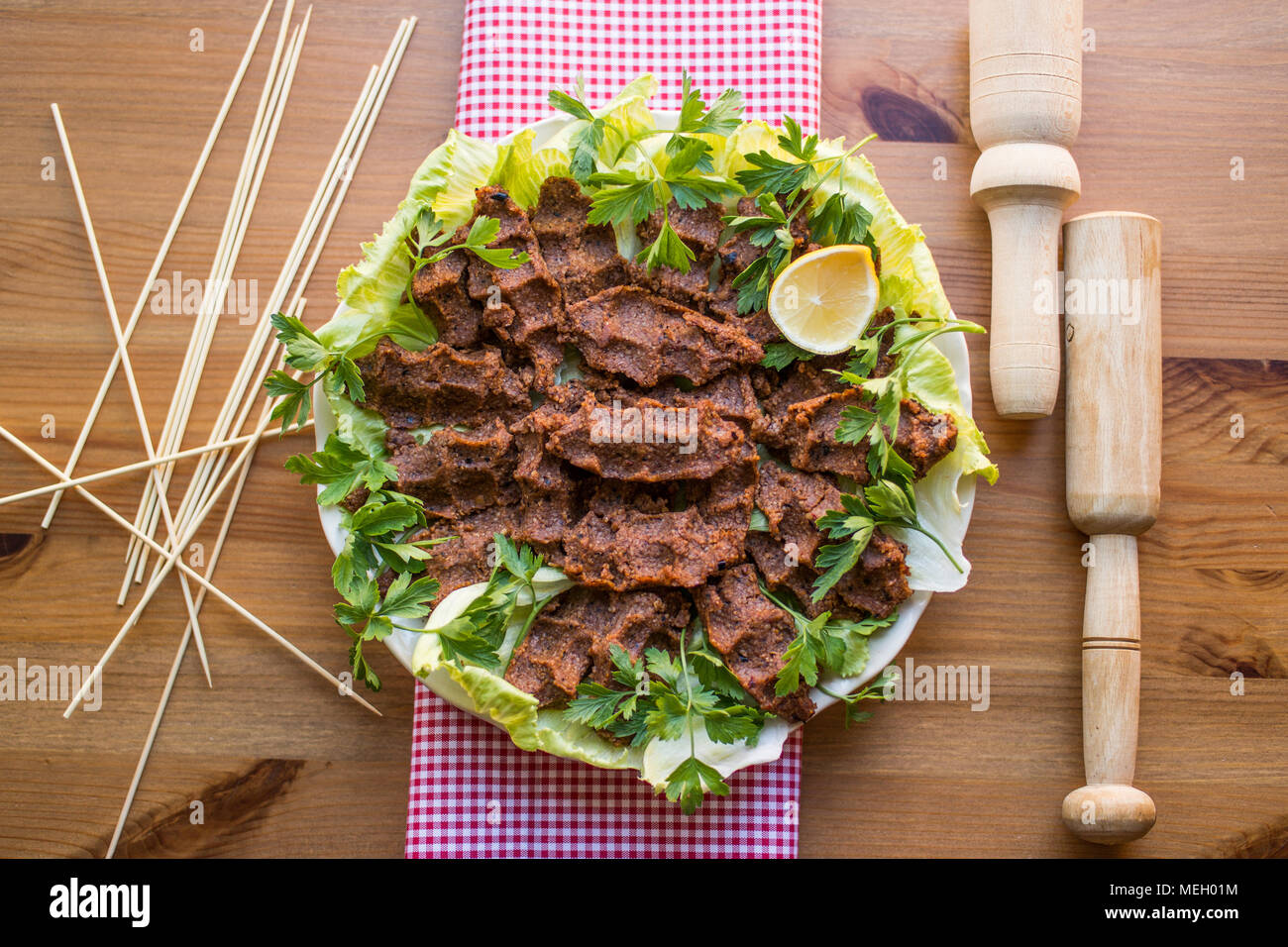 Turkish Food Cig Kofte with lemon, lettuce and parsley on silver tray ...