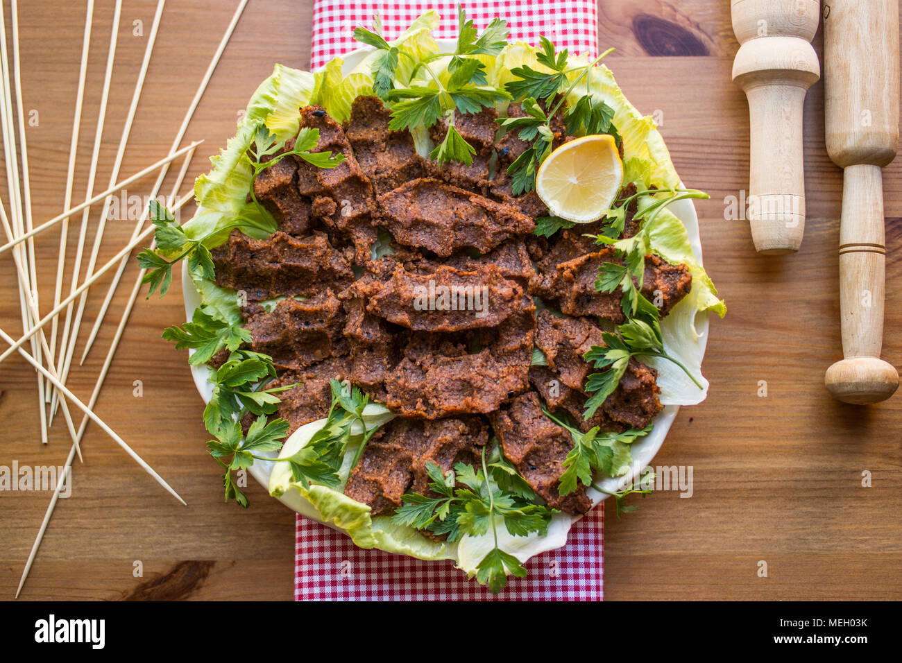 Turkish Food Cig Kofte with lemon, lettuce and parsley on silver tray ...