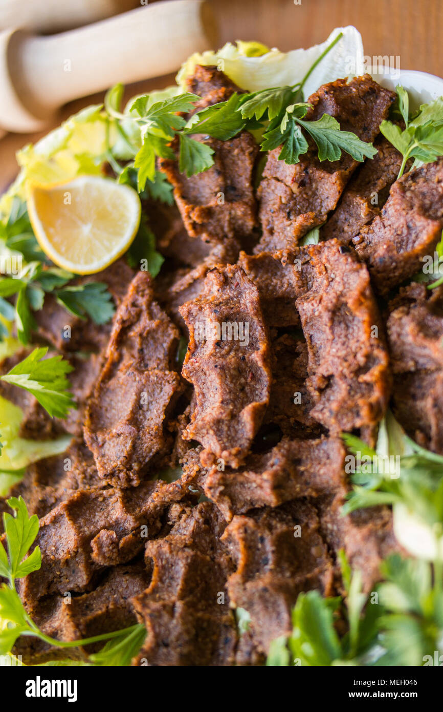 Turkish Food Cig Kofte with lemon, lettuce and parsley on silver tray ...
