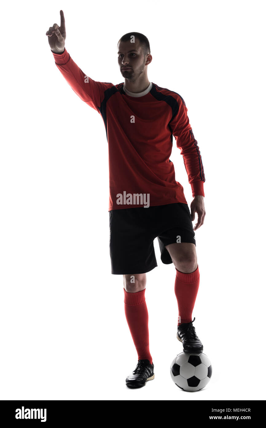Silhouette of young football player pointed with finger with soccer ...