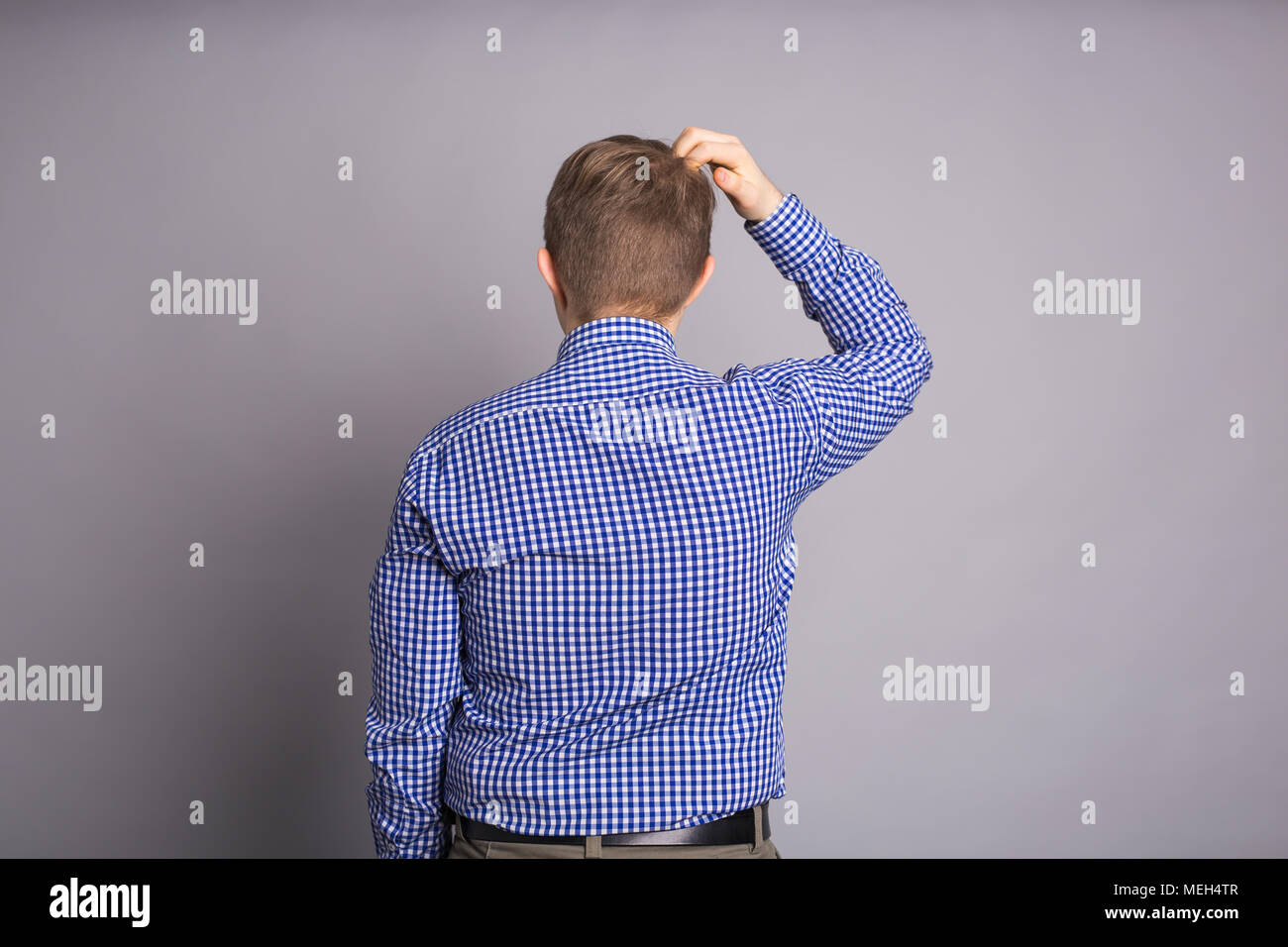 Forgetful absent minded man is trying to remember something, back view ...