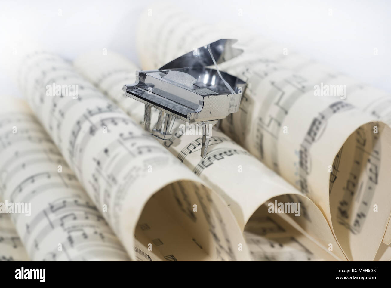 Abstract photo of music. Small metal piano with notes book. Piano Jazz ...