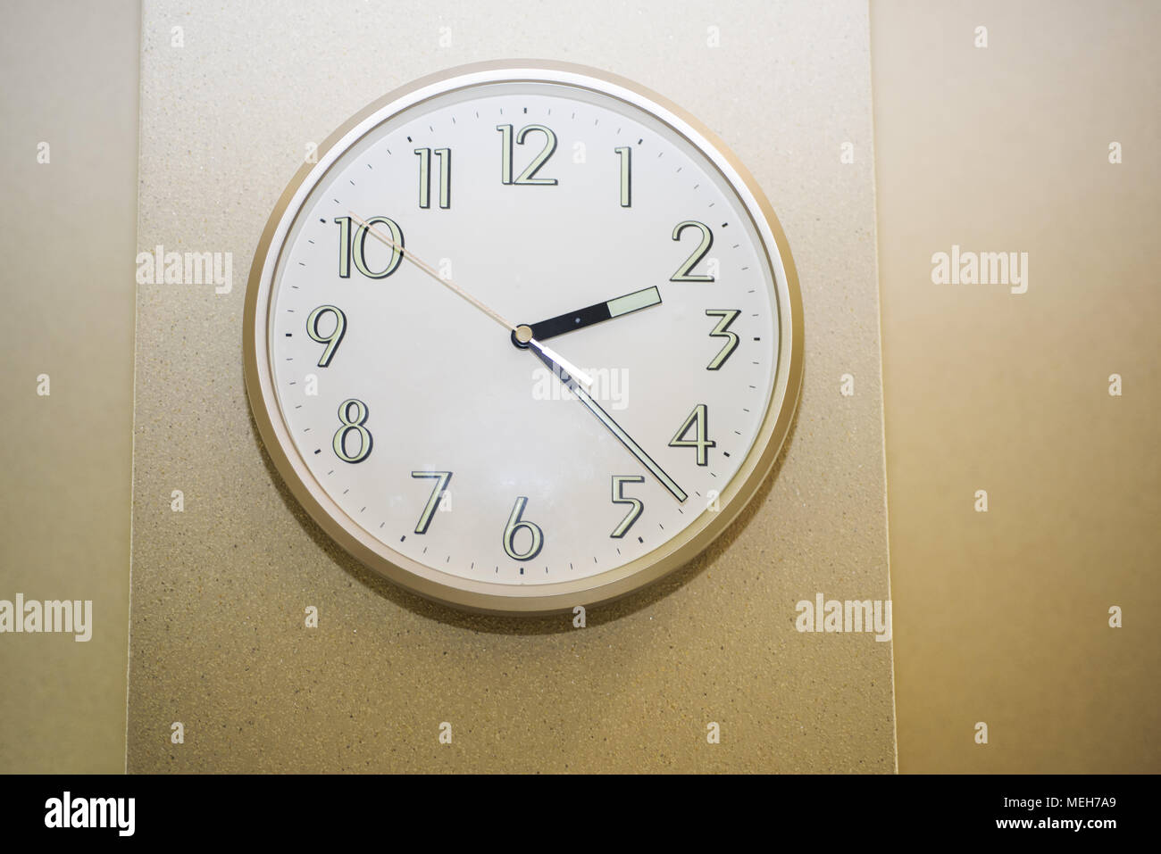 Simple wall clock on wooden texture. Isolated object Stock Photo - Alamy