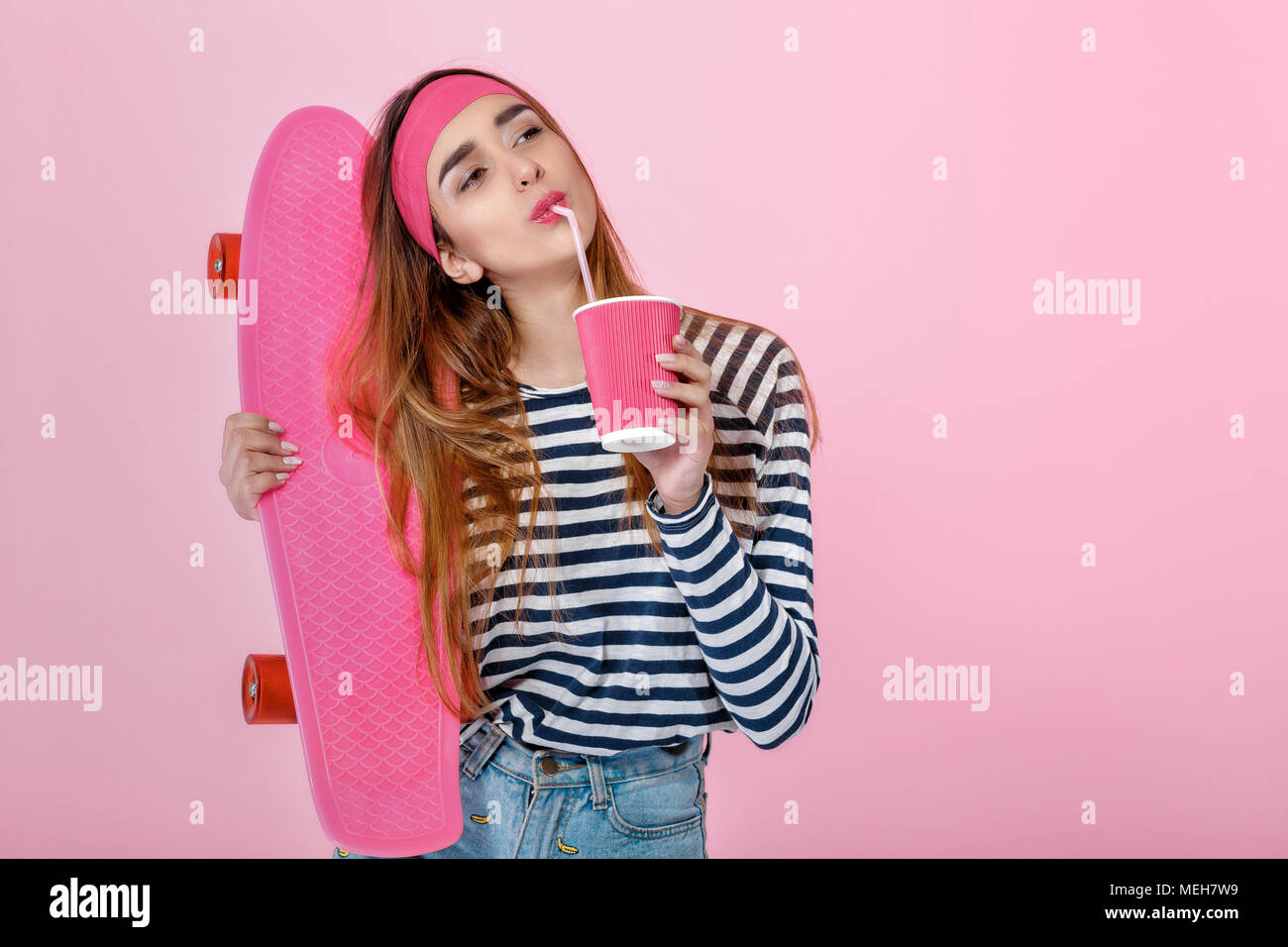 beautiful woman with skate in studio Stock Photo - Alamy