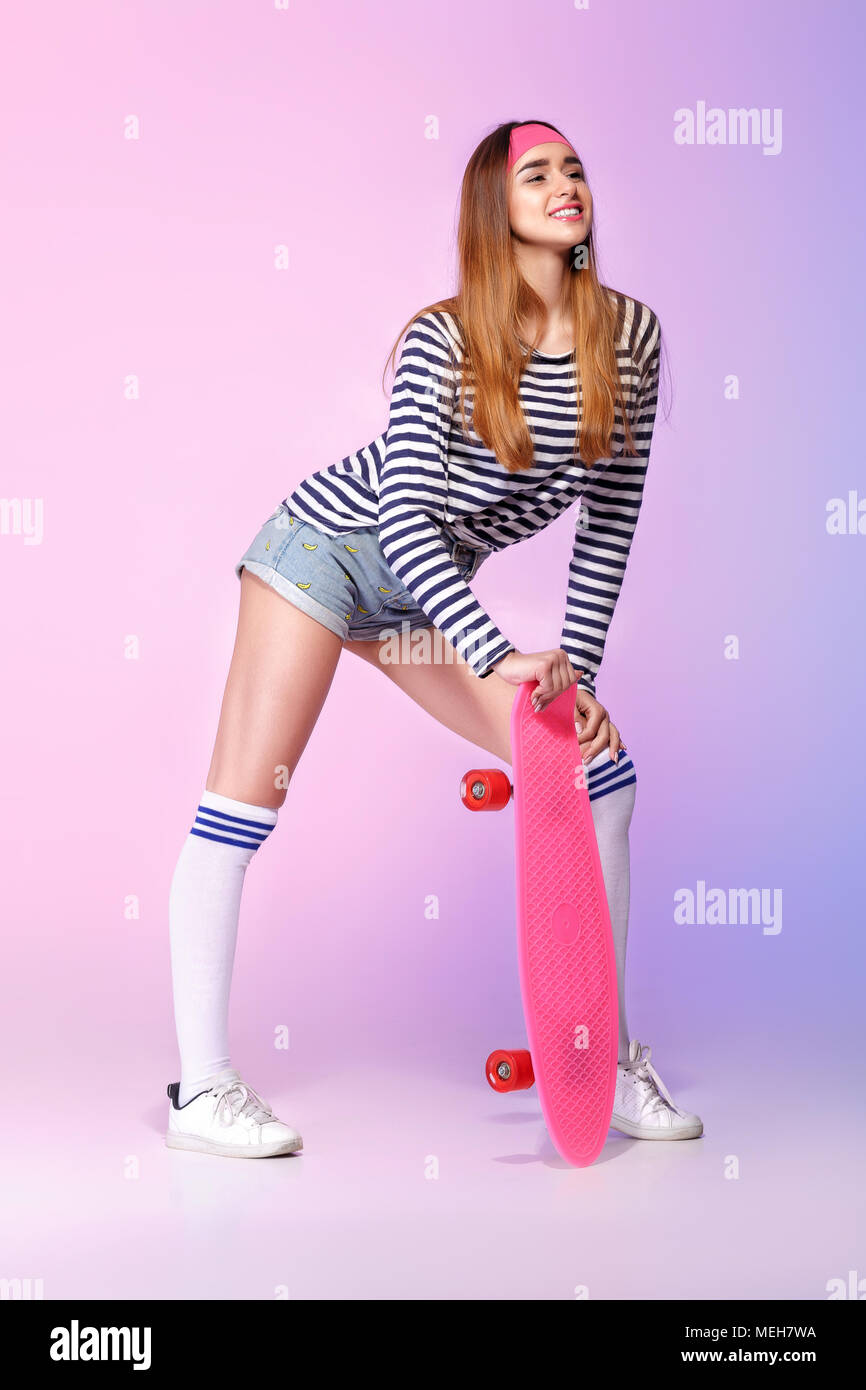 beautiful woman with skate in studio Stock Photo - Alamy