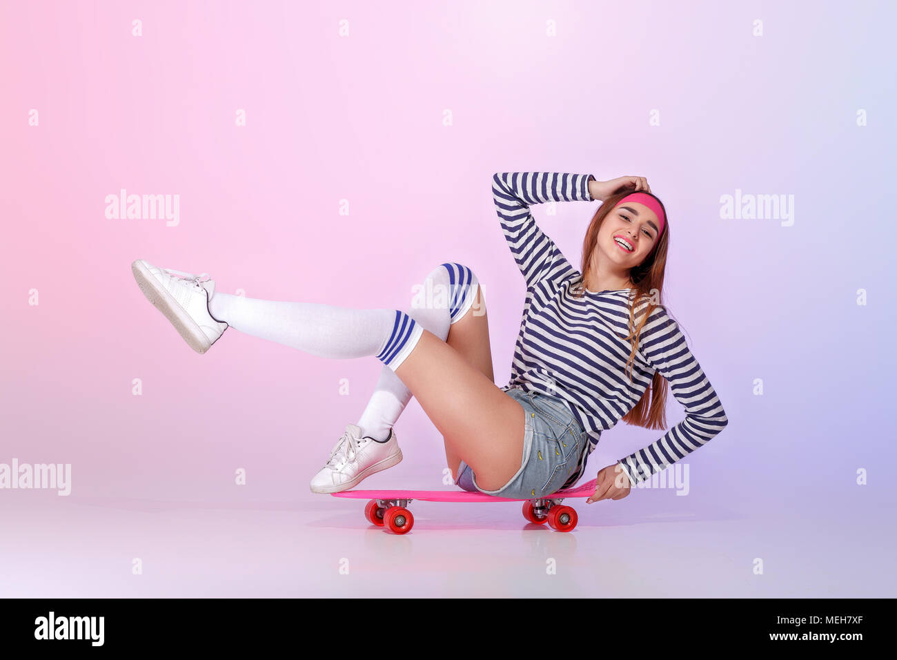 beautiful woman with skate in studio Stock Photo - Alamy