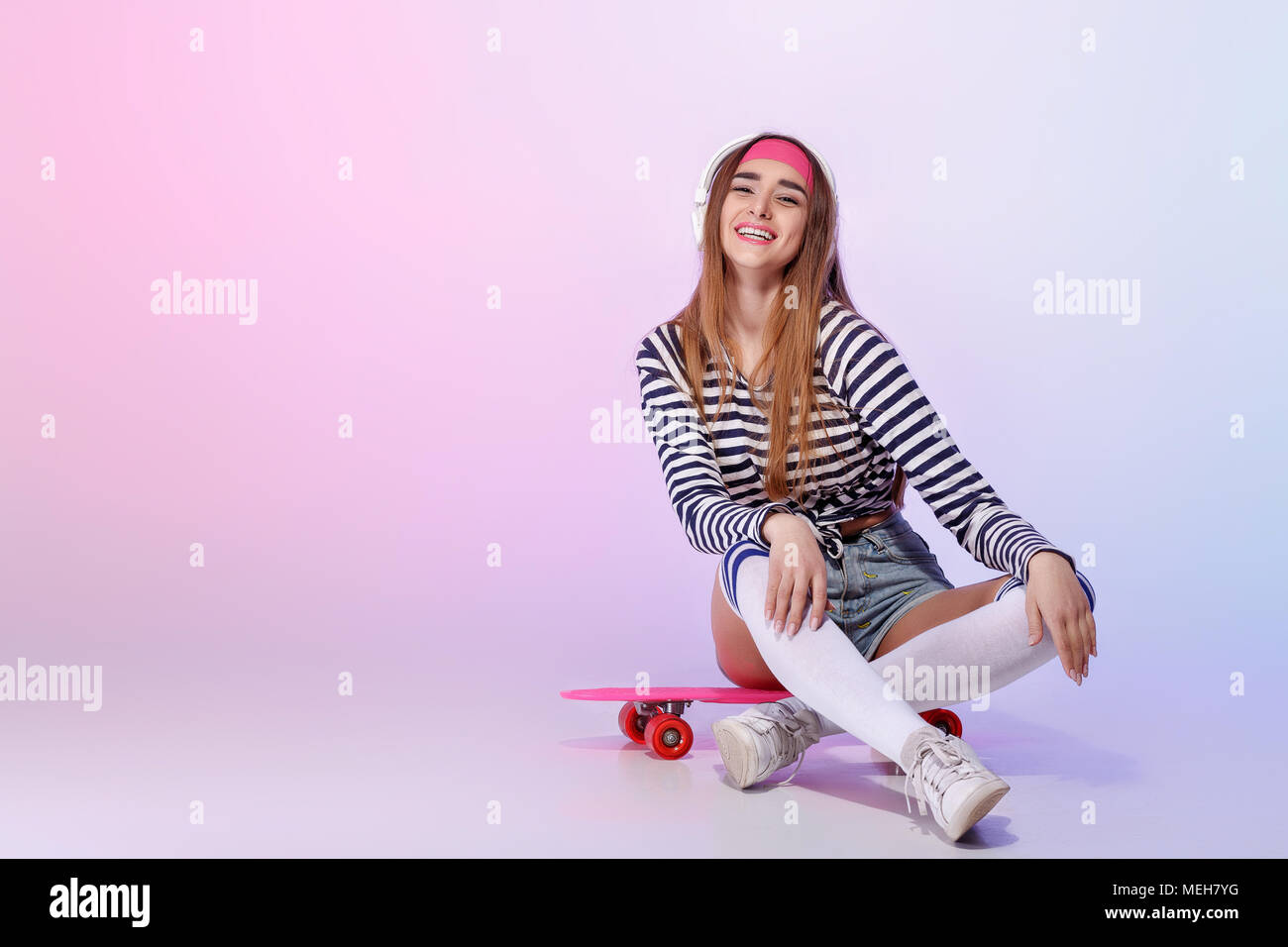 beautiful woman with skate in studio Stock Photo - Alamy