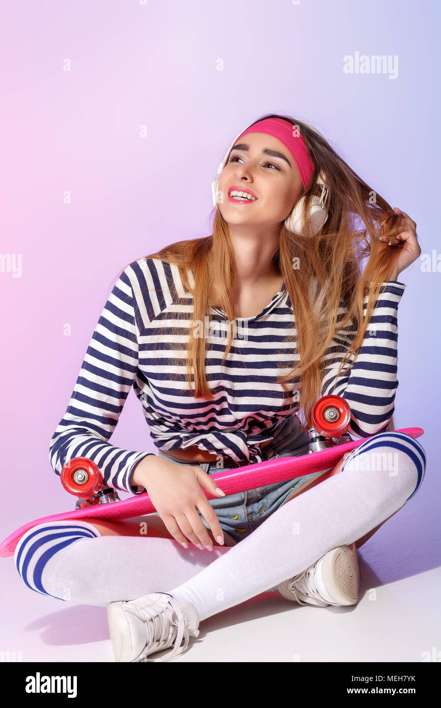 beautiful woman with skate in studio Stock Photo - Alamy