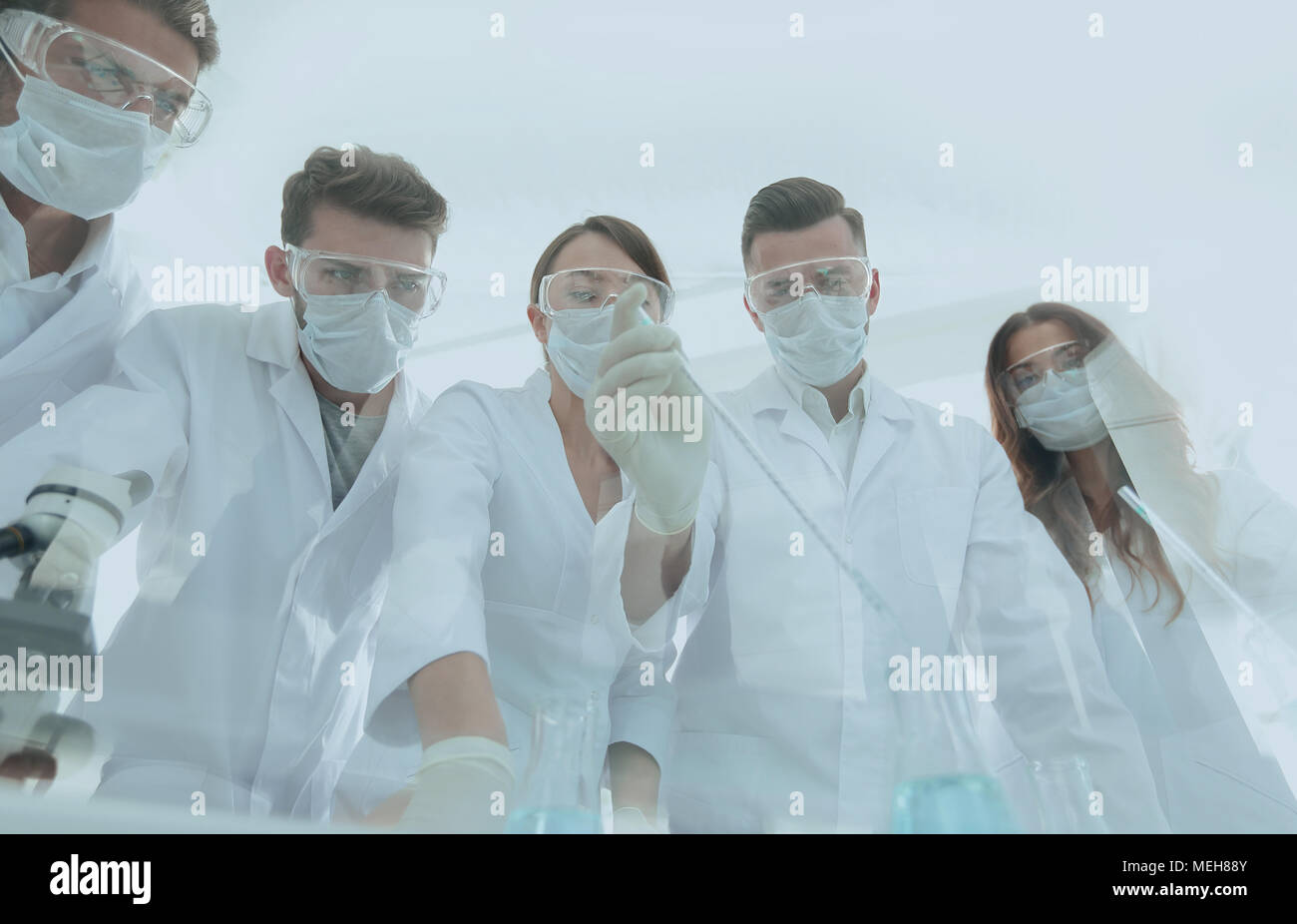 scientists working with test tubes and microscope in the laboratory ...