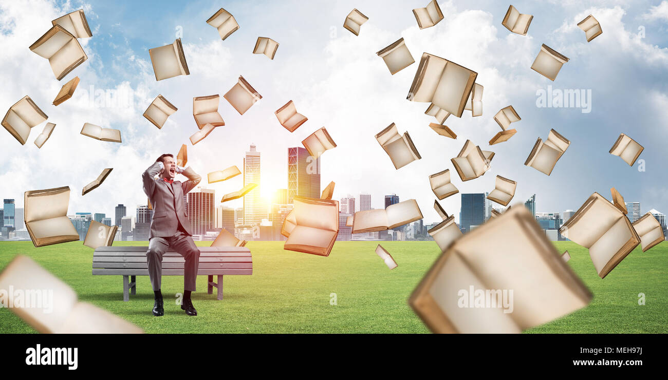 Many old books falling from above and student guy sitting on bench ...