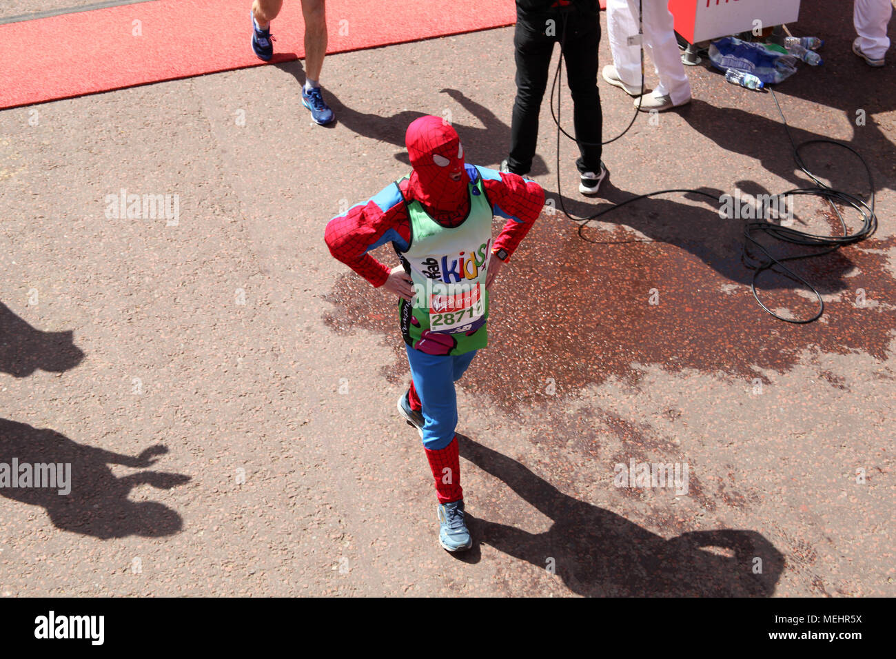 London, UK, 22 April 2018. Man dressed as Spiderman crosses the finish ...