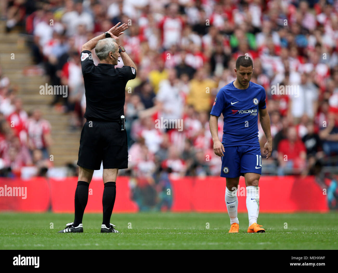 London, UK, 22 April 2018. Referee Martin Atkinson holds his stopwatch ...