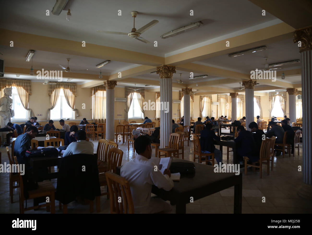 Mazar I Sharif. 23rd Apr, 2018. Students read books at a library in ...