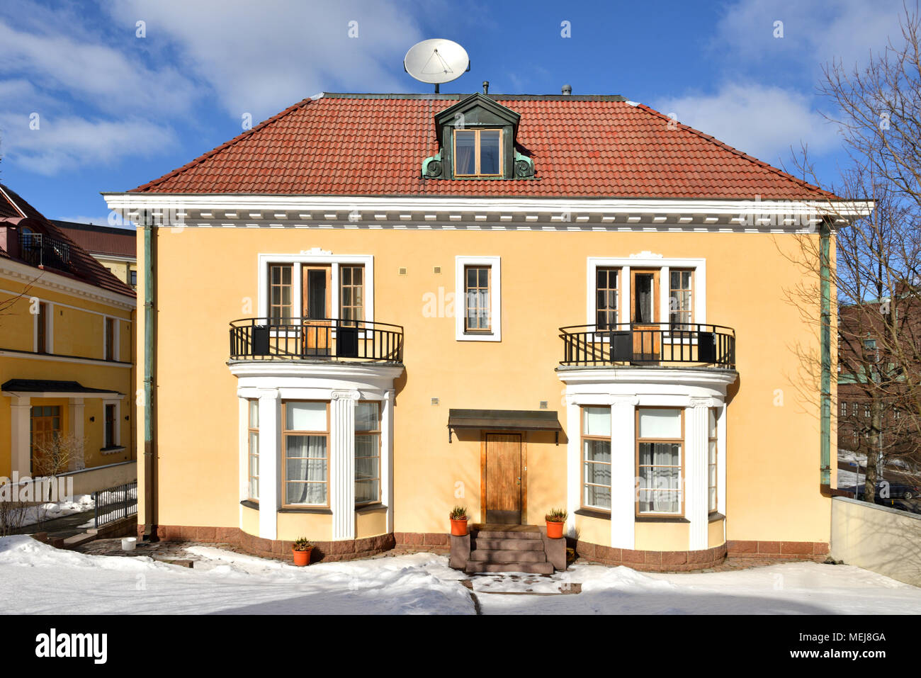 Stone yellow two-storey house with balconies Stock Photo - Alamy