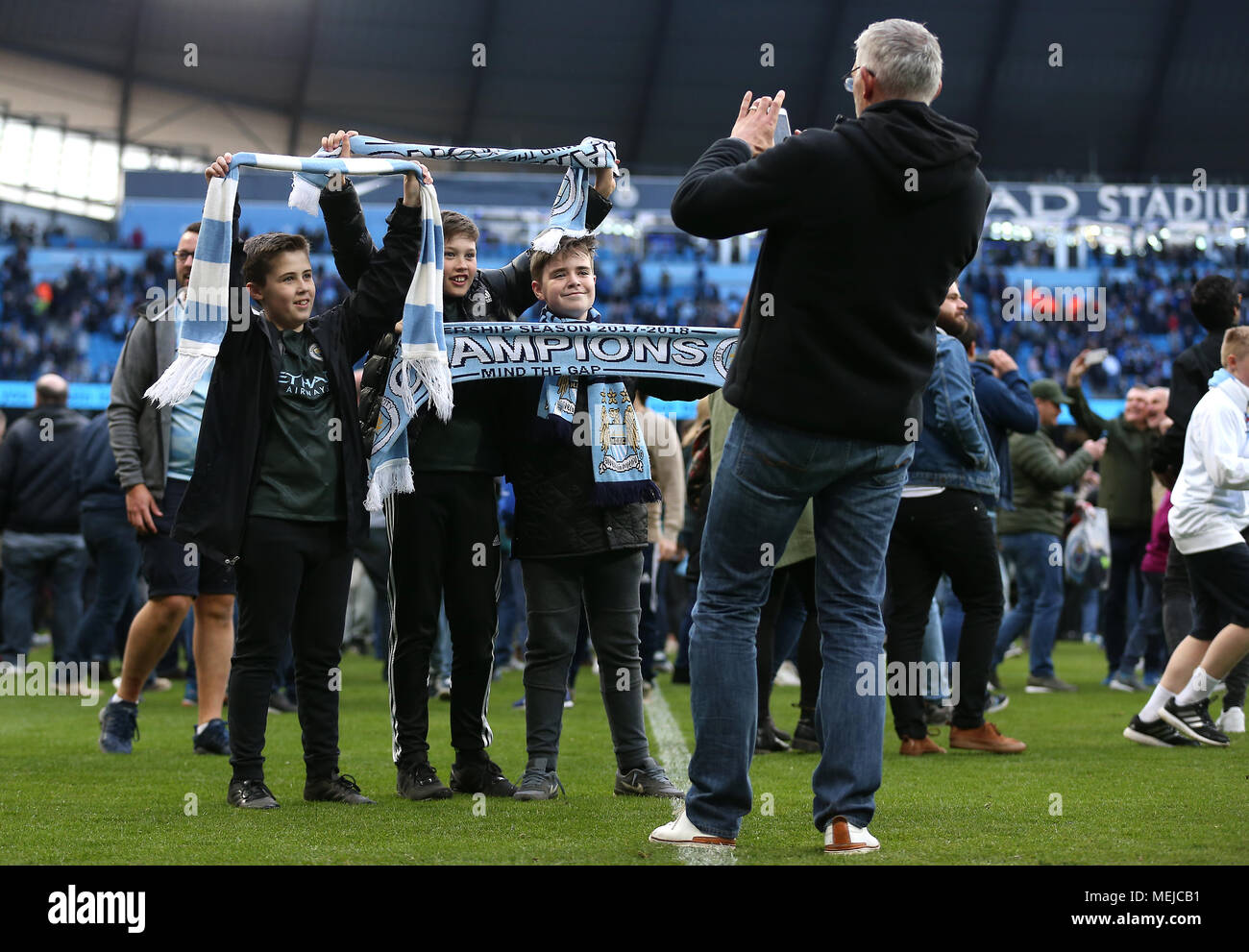 Fans invade the pitch after the final whistle during the Premier League ...