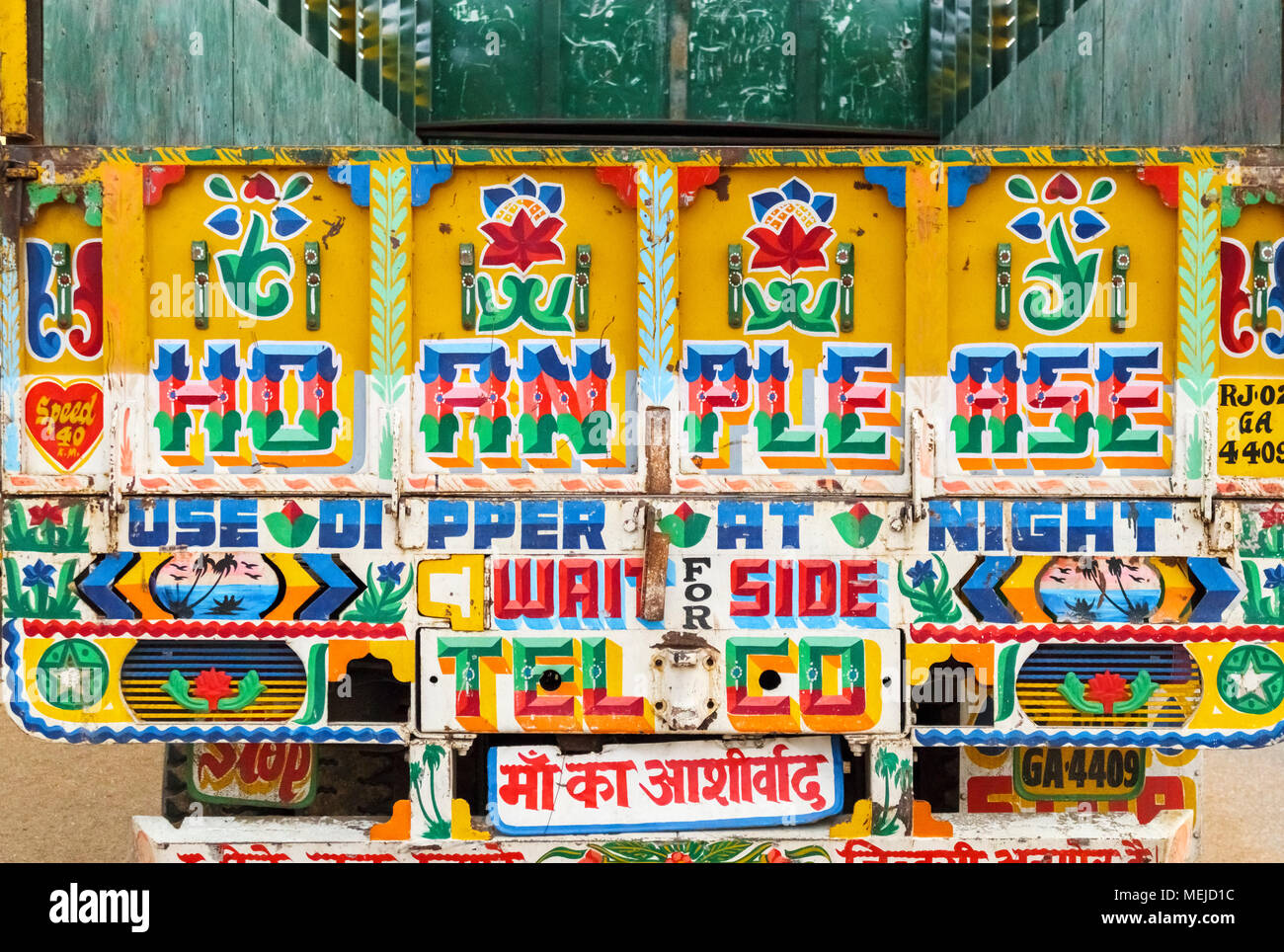 Driving in India: view of a typical brightly coloured back of an Indian ...