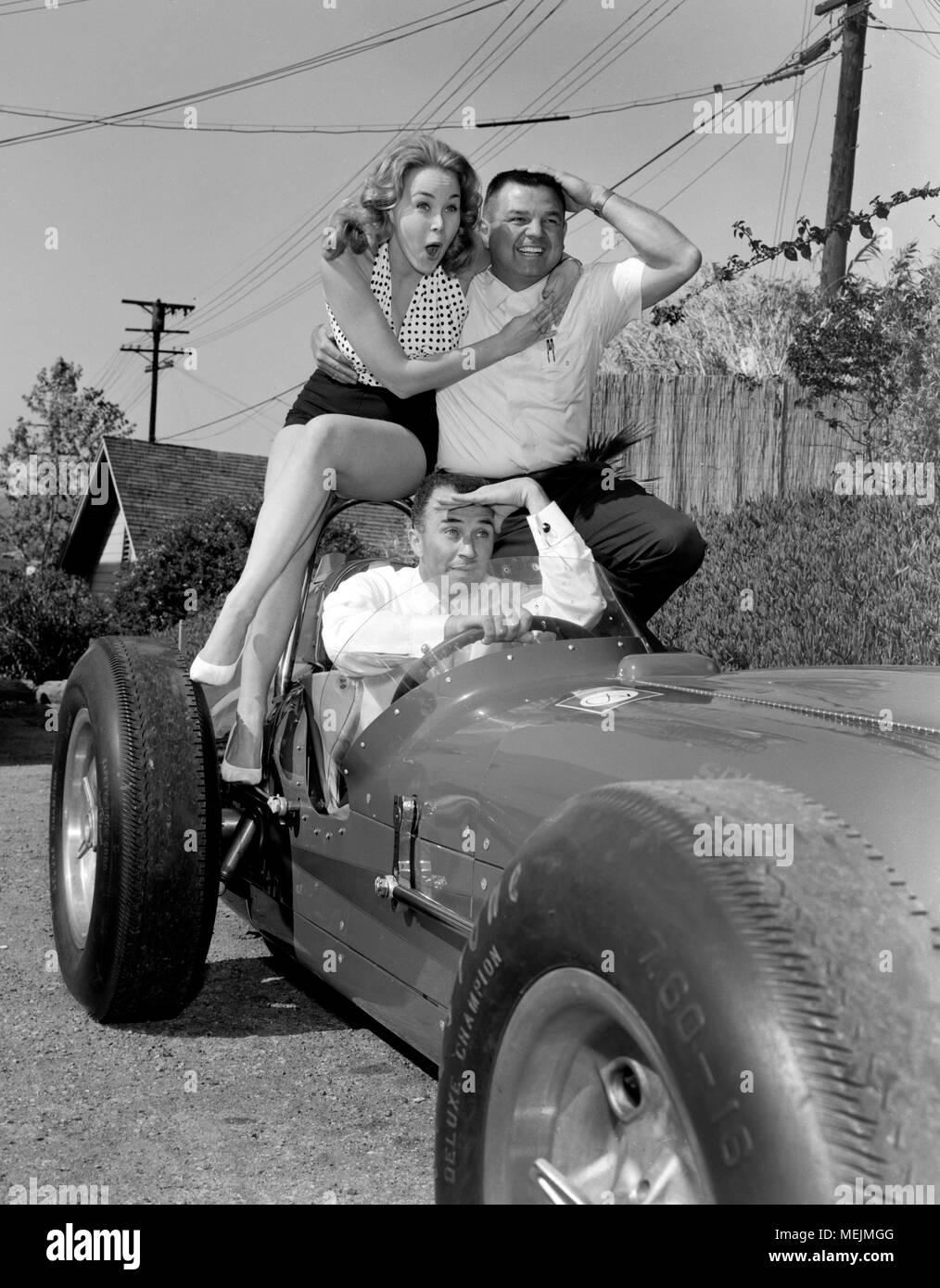 A model and two car racing executives have fun in a promotional picture ...
