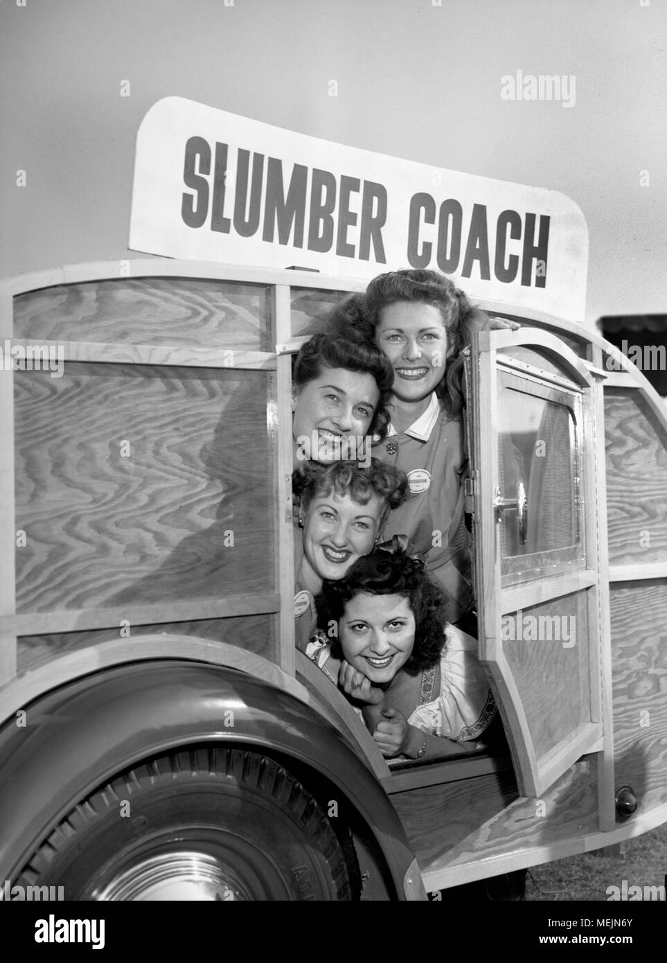Four models crowd in a Slumber Coach camping travel trailer at a ...