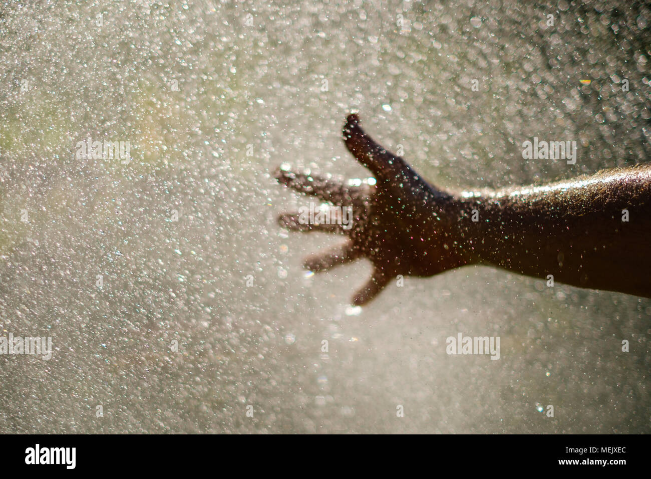 Water drops and hand - holding hand in water splash Stock Photo - Alamy