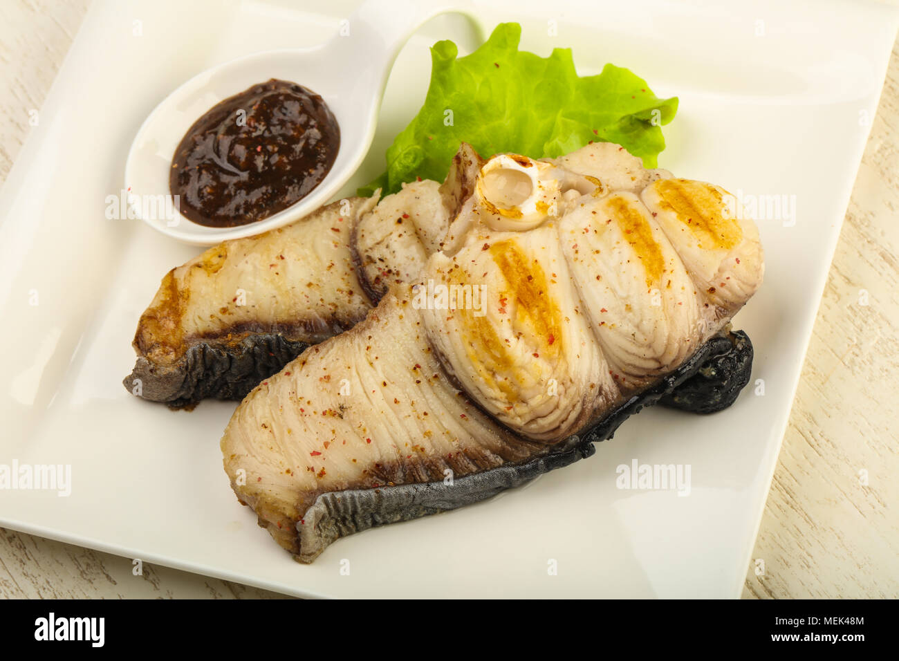 Grilled shark steak with pepper sauce and salad leaves Stock Photo - Alamy