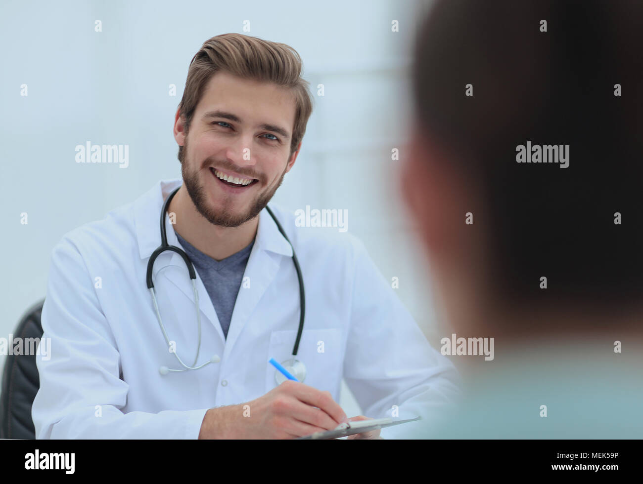 closeup.doctor writing a prescription to her patient Stock Photo - Alamy
