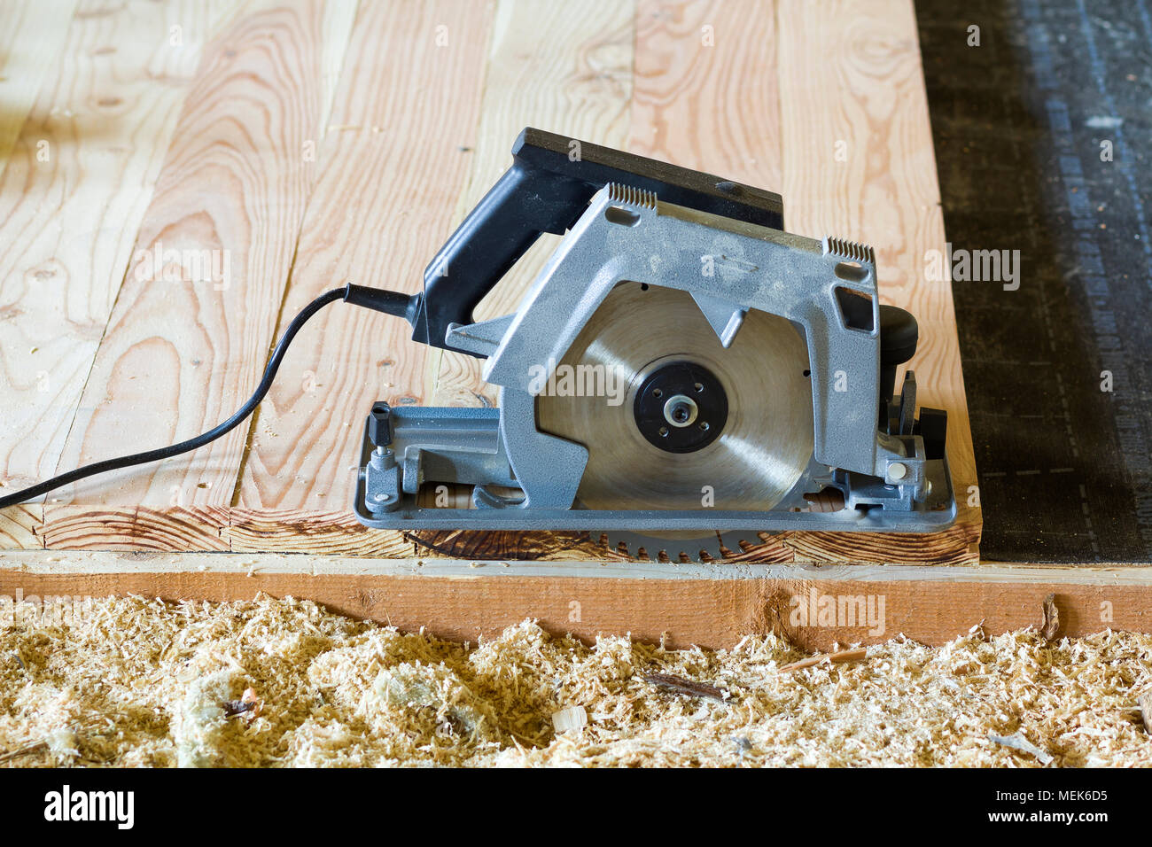 Close-up of new modern powerful circular electrical saw cutting wooden ...