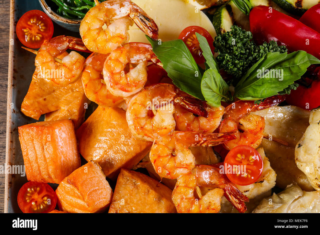Fish and prawn plate served grilled vegetables Stock Photo - Alamy