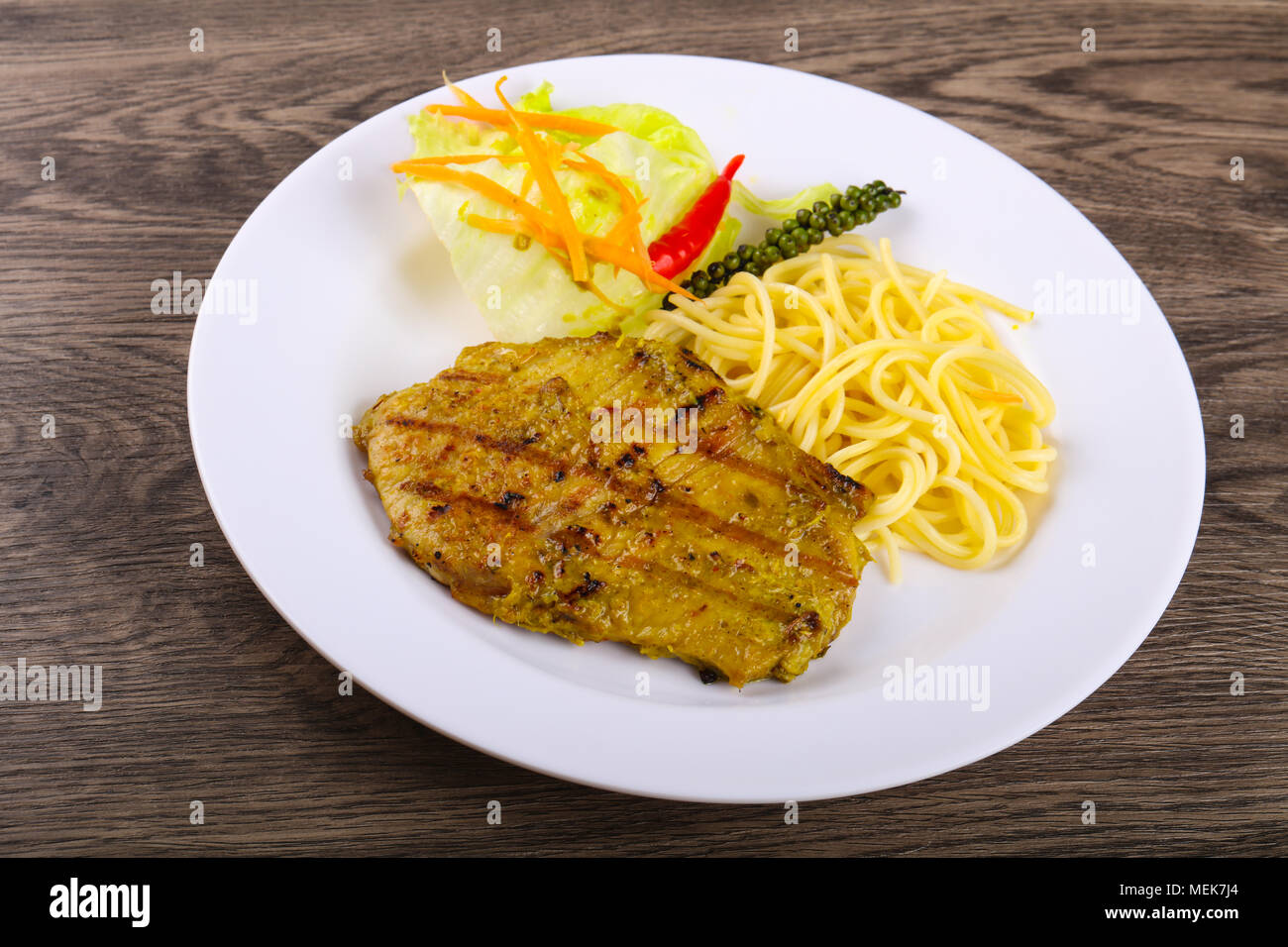Grilled pork meat with green curry and pepper Stock Photo - Alamy