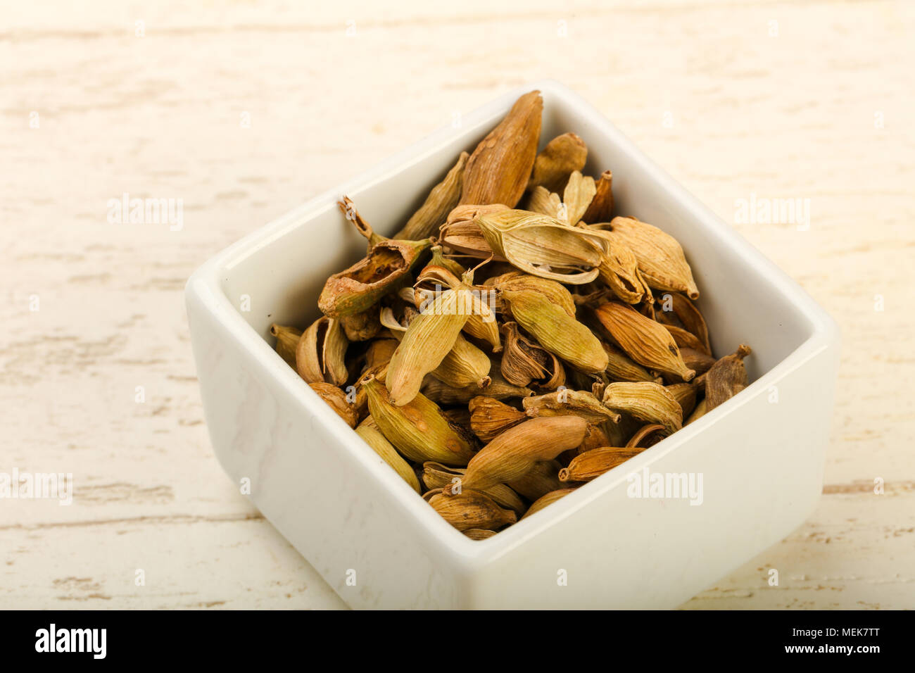 Dry cardamom seeds heap in the bowl Stock Photo - Alamy