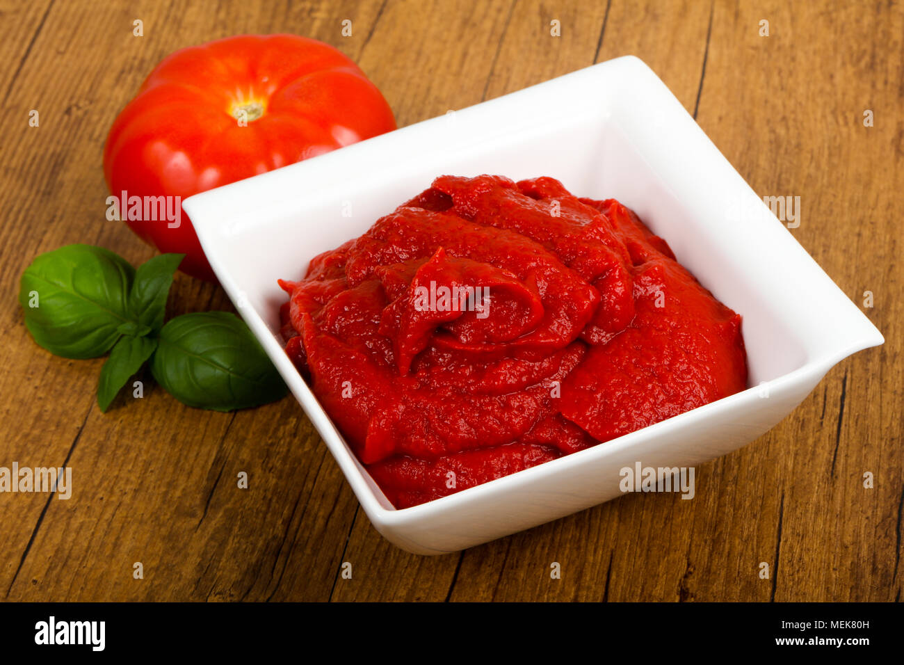 Tomato paste with basil leaves Stock Photo - Alamy