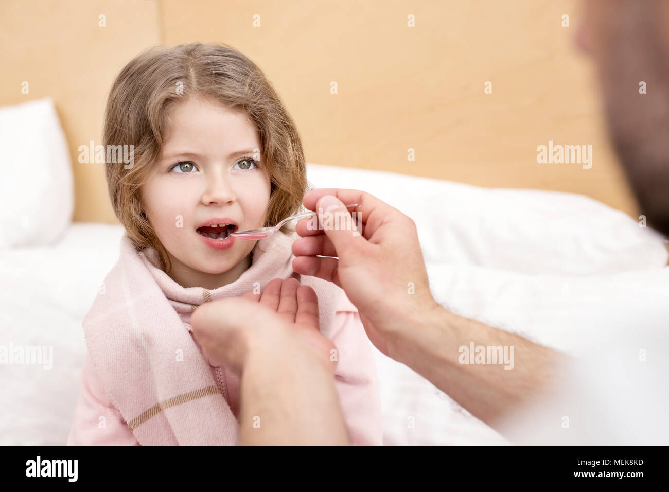 Sweet girl taking some medicine Stock Photo - Alamy