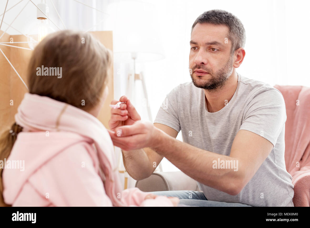 Devoted father giving medicine to his daughter Stock Photo - Alamy