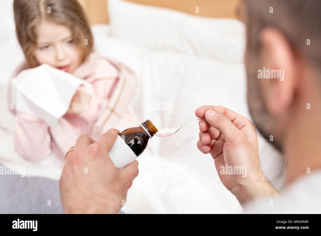 Concerned father giving medication to his daughter Stock Photo - Alamy
