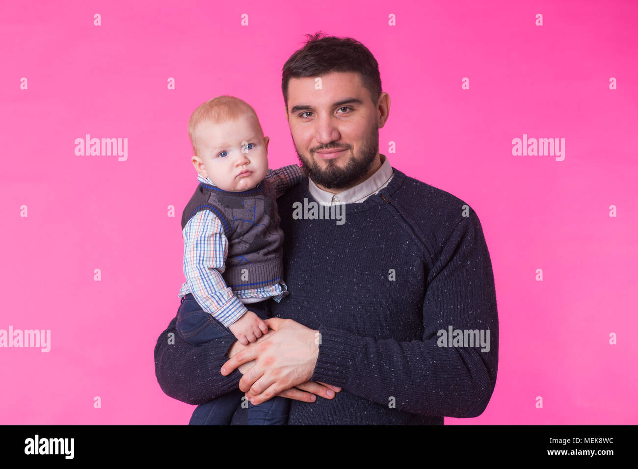 happy father with a baby son isolated on a pink background Stock Photo ...