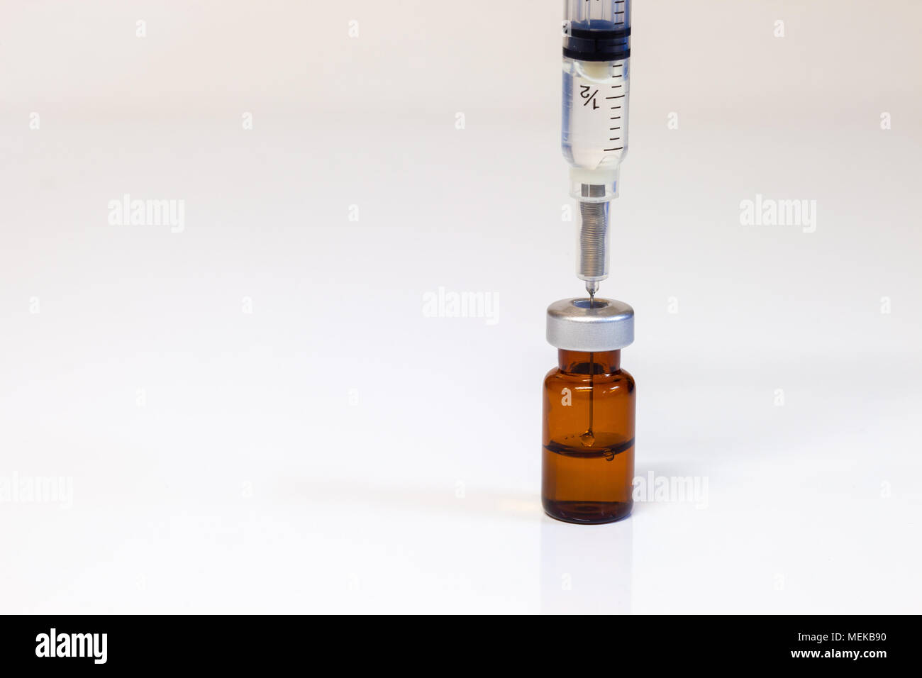 Medical Syringe and a vial of an intravenous drug on a white background ...