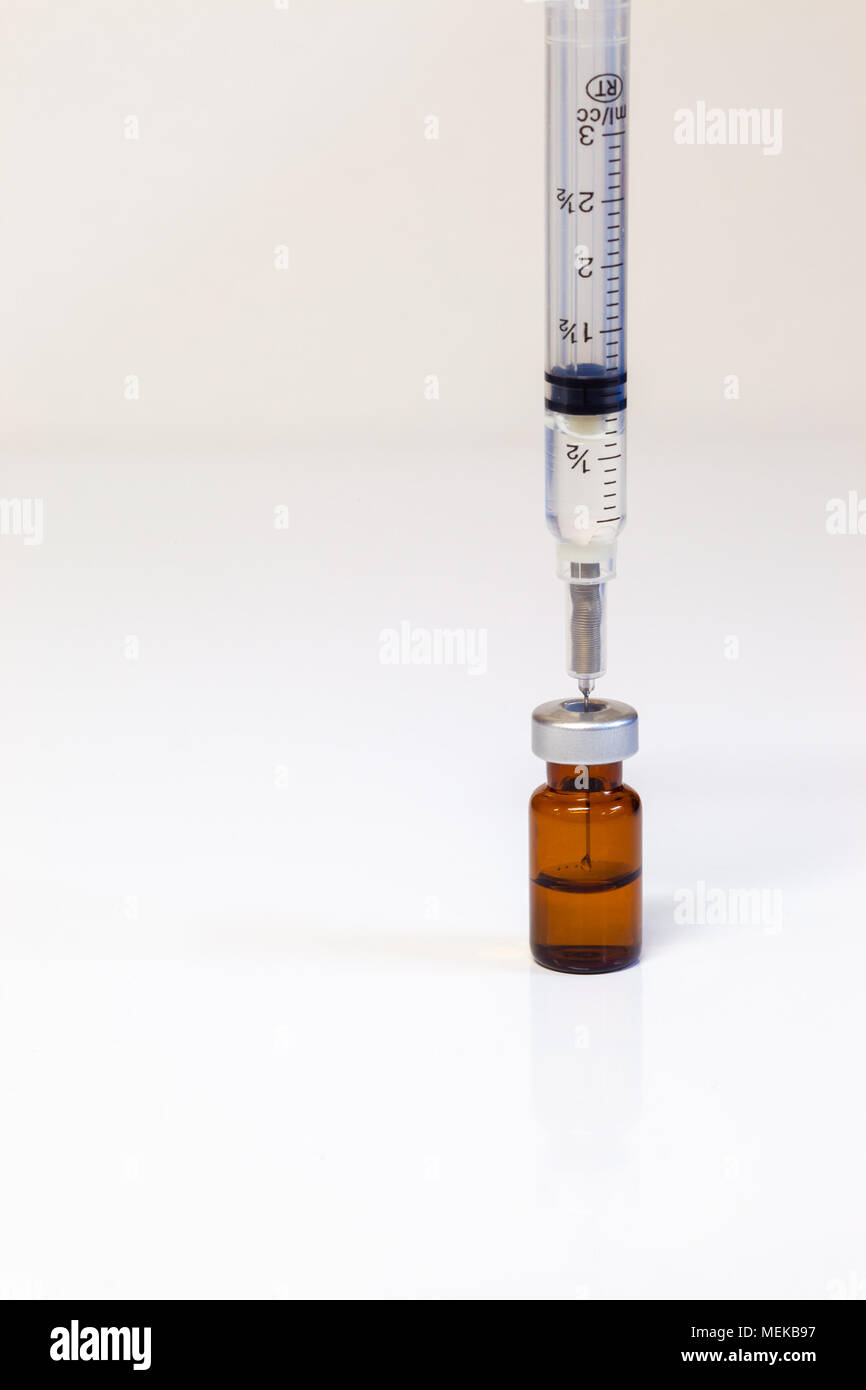 Medical Syringe and a vial of an intravenous drug on a white background ...