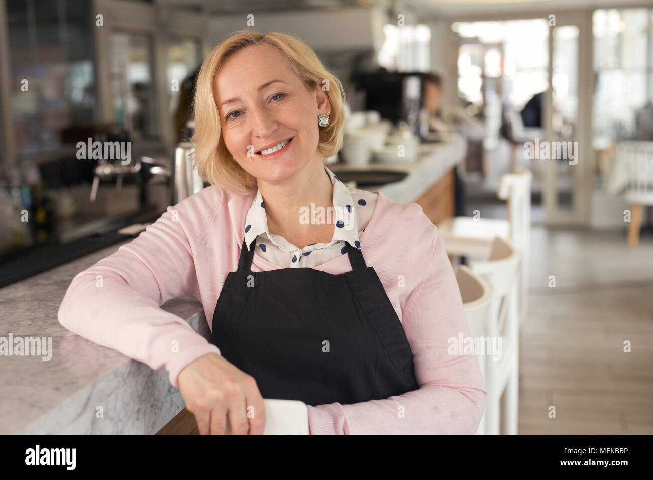 Glad waitress waiting for her clients Stock Photo - Alamy