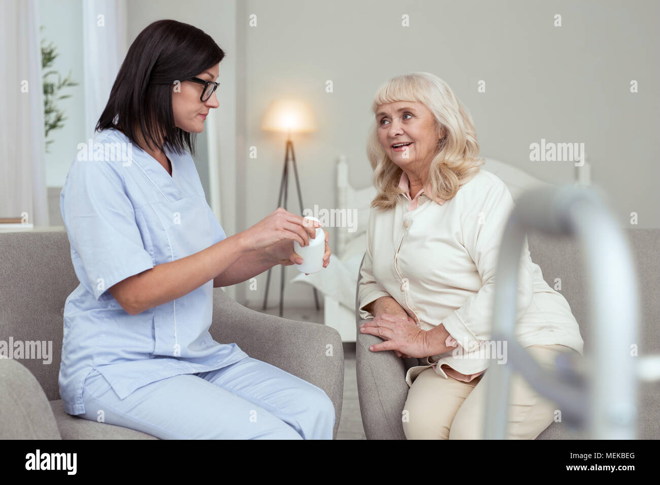 Concentrated pretty nurse supplying drugs Stock Photo - Alamy