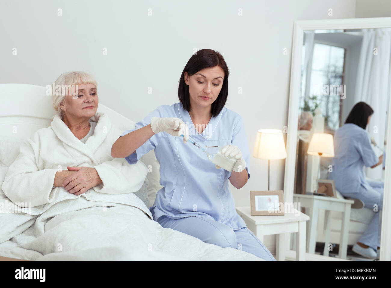 Focused appealing nurse preparing medication Stock Photo - Alamy