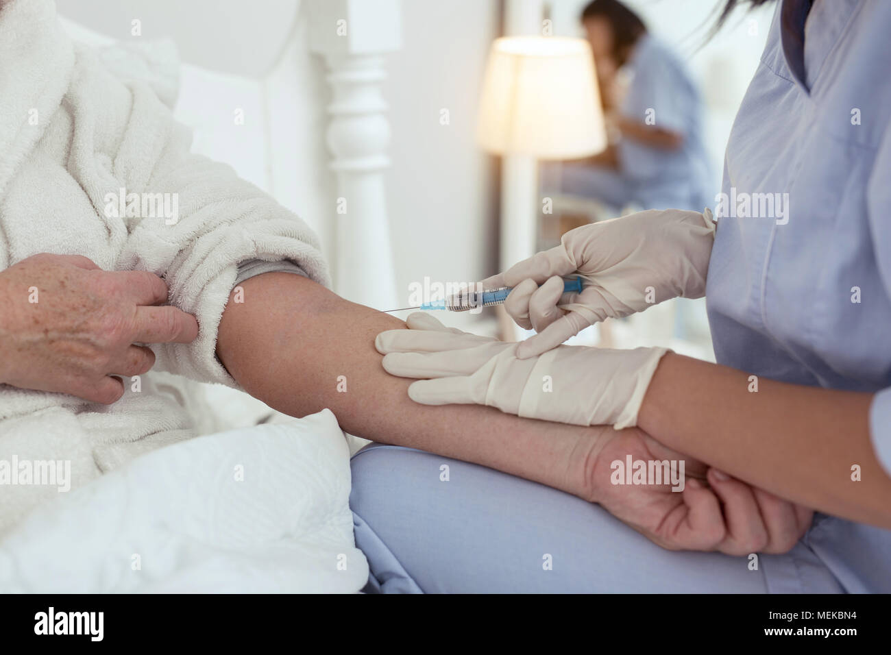 Professional nurse performing injection Stock Photo - Alamy