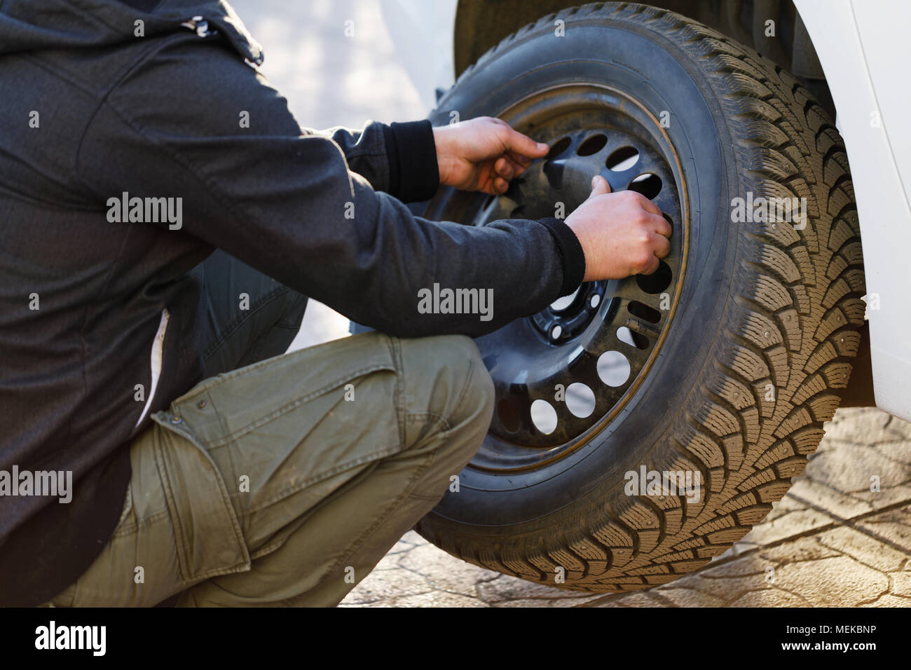 Working process of removing the wheel from the car. Replacing winter ...